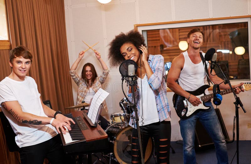 Multiracial Music Band Performing in a Recording Studio Stock Photo ...