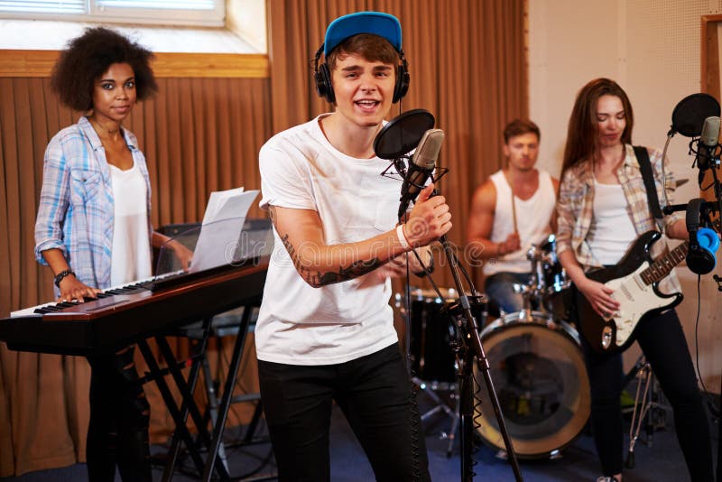 Multiracial Music Band Performing in a Recording Studio Stock Photo ...