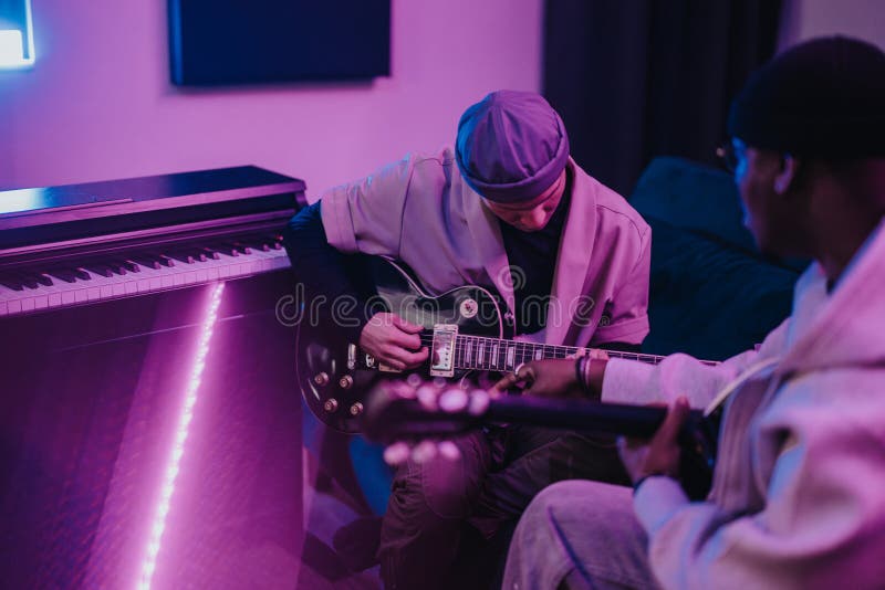 Multiracial Musicians Collaborating in a Studio Setting with Guitars ...
