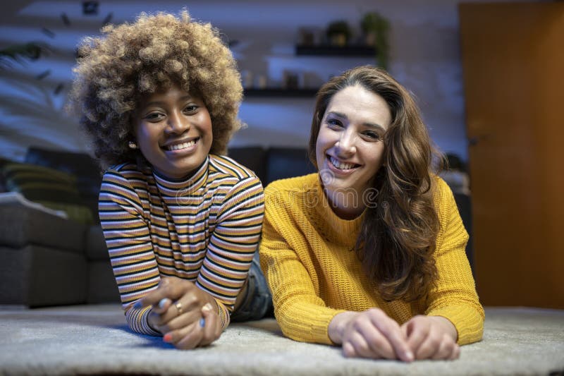 Multiracial Smiling Lesbian Couple Looking At Camera Portrait Of Two