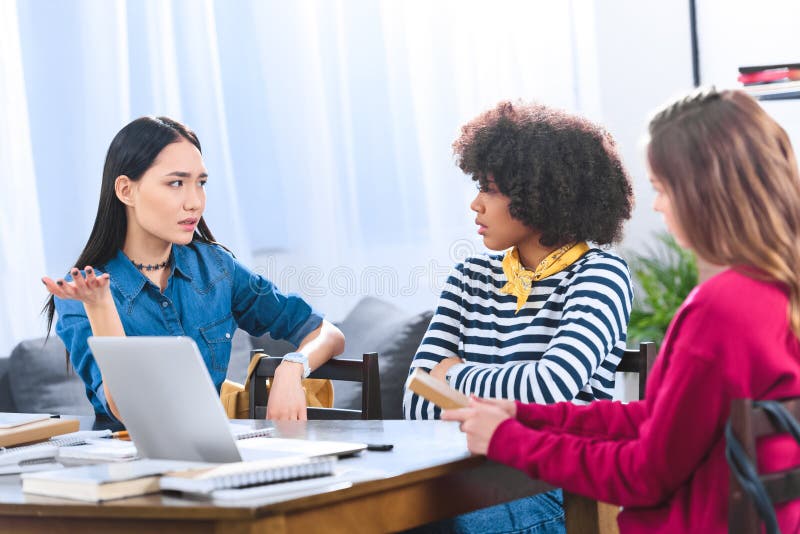 Multiracial Students Having Discussion while Doing Stock Photo - Image ...
