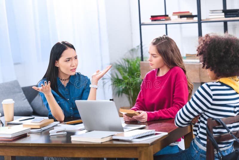 Multiracial Students Having Discussion while Doing Stock Photo - Image ...