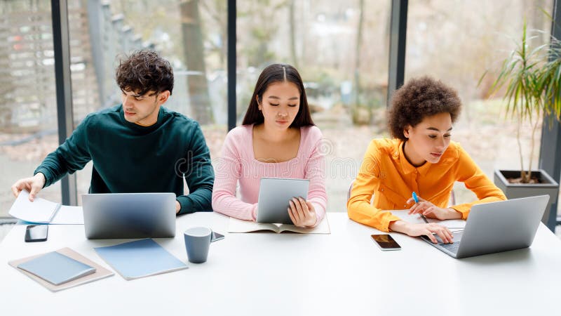Multiracial Students Sitting in University Audience, Using Various ...