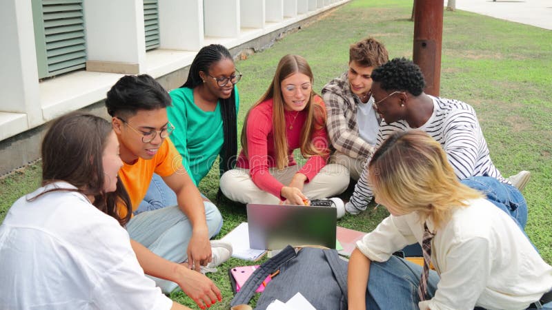 Multiracial Students Using a Laptop Computert Sitting in a Circle on ... Multiracial Students Using a Laptop Computert Sitting in a Circle on ...
