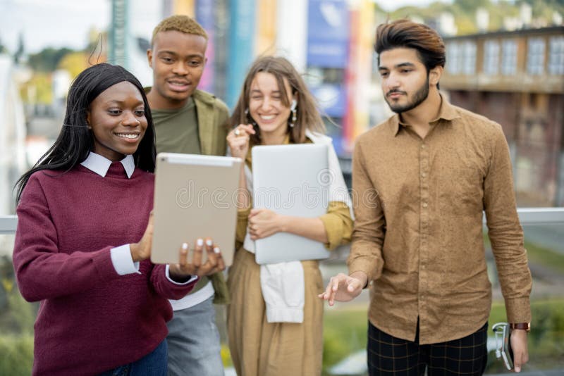 Multiracial Students Watch Some on Digital Tablet Stock Image - Image ...
