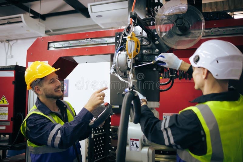 Multiracial Tachnicial Engineer Training with Robot Arm Stock Photo ...