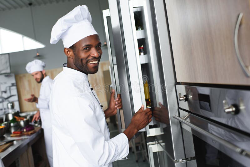 Multiracial Team of Cooks Working on Professional Stock Image - Image ...