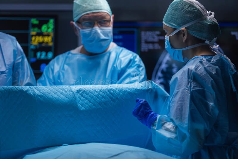 Multiracial Team of Professional Medical Surgeons Performs the Surgical ...