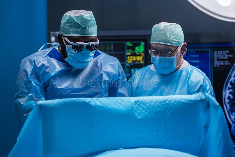Multiracial Team of Professional Medical Surgeons Performs the Surgical ...