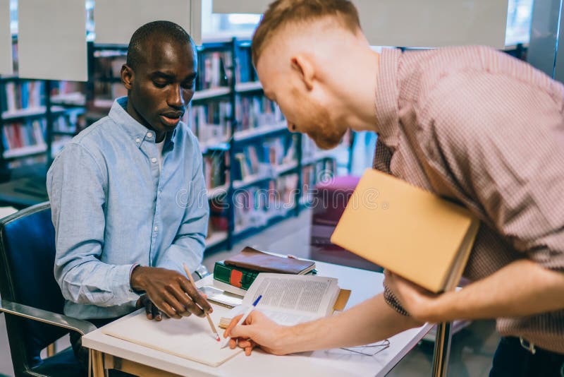 Multiracial Team of Students Cooperating in Library Stock Image - Image ...