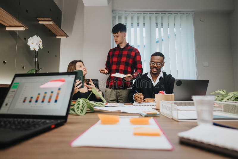 Multiracial Team of Young Businesspeople Analyzing Project Data in ...