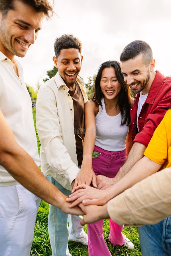 Multiracial Young Happy Friends Stacking Hands at City Park Stock Image ...