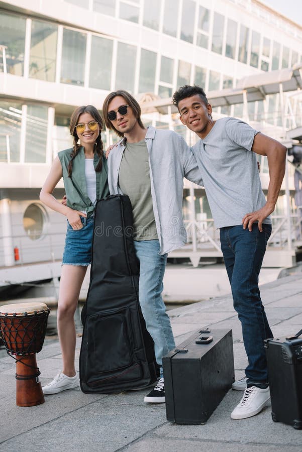 Multiracial Musical Band Walking and Carrying Musical Instruments on ...