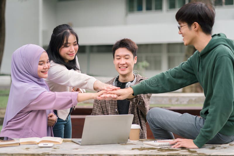 Multiracial Young People Stacking Hands Together while Standing Outside ...