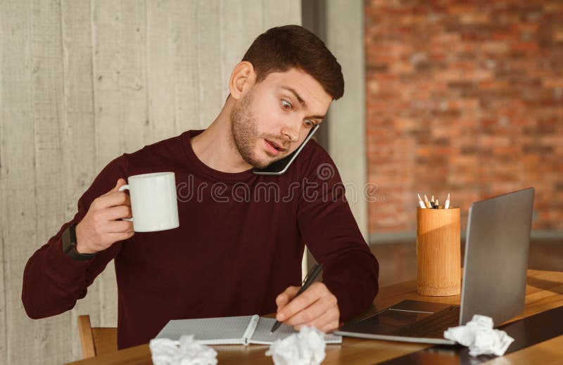 Overwhelmed Man Multitasking Talking on Phone Sitting in Office Stock ...