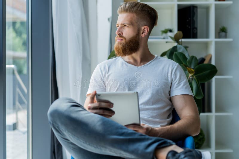 Multitasking. Handsome Young Man Wearing Glasses and Working with ... Multitasking. Handsome Young Man Wearing Glasses and Working with ...