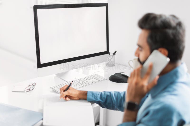Multitasking Man Talking on Phone while Writing Notes Stock Photo ...