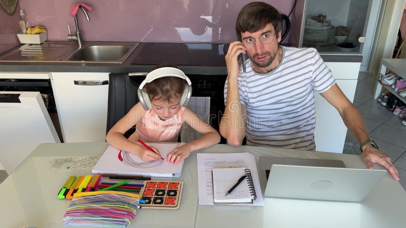 Father Working from Home and Having a Phone Call while His Daughter is ...