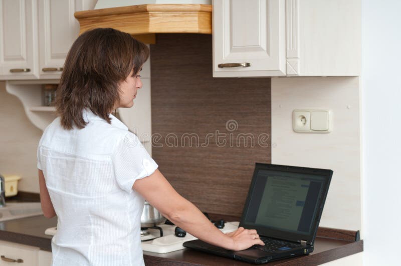 Multitasking - Preparing Meal and Working Stock Photo - Image of ...