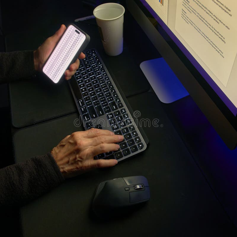 Multitasking with Smartphone and Computer in Office Setting Stock Photo ...