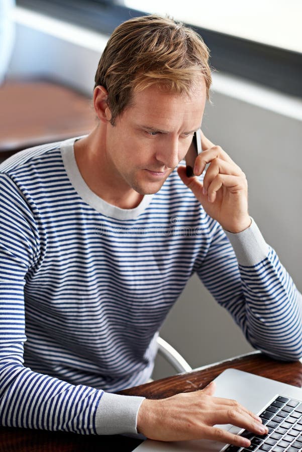 Multitasking with Technology. a Man Talking on His Cellphone in a ...