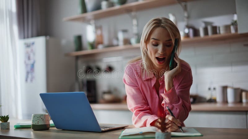 Multitasking Woman Talking Mobile Phone Typing Laptop at Modern Kitchen ...