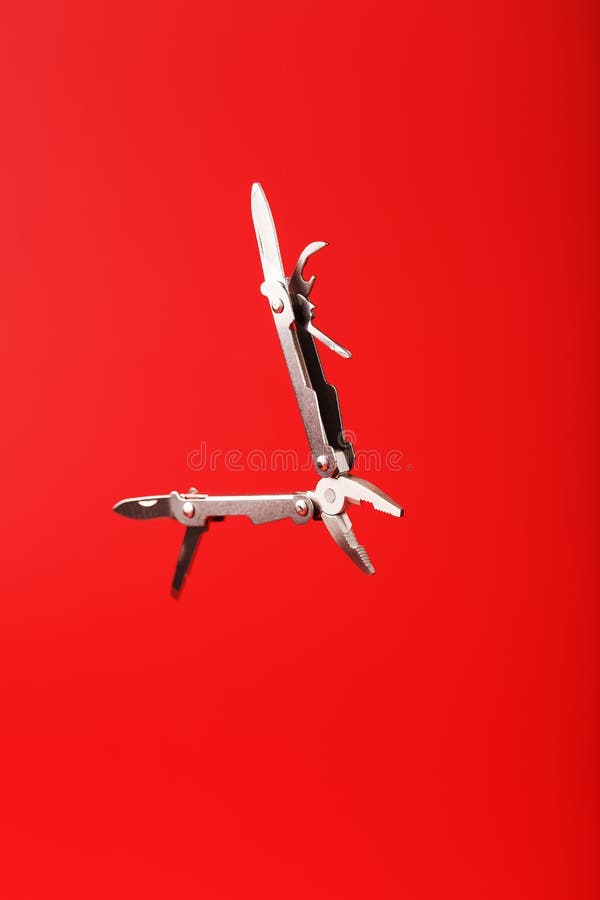 Multitool is a Multi-functional Tool on a Red Background. the Concept ...