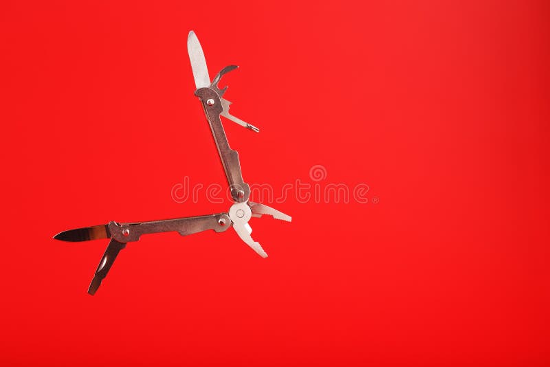 Multitool is a Multi-functional Tool on a Red Background. the Concept ...