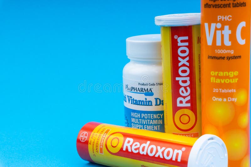 Multivitamin Tablets and Vitamin C Container Closeup. Editorial Stock ...