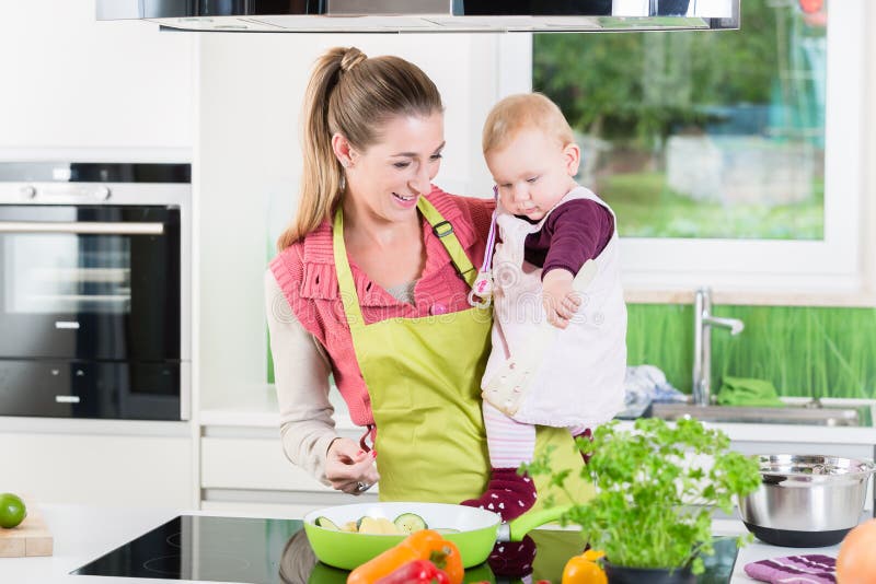 Mum Cooking with Baby in Arm Stock Image - Image of daughter, household ...