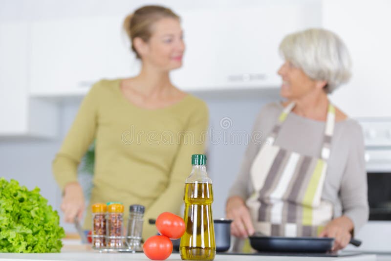 Mum and Daughter Happily Talking while Cooking in Kitchen Stock Photo ...