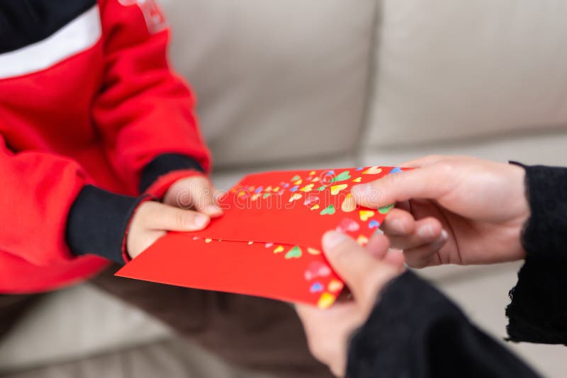 Mum Giving Red Pocket To Her Son Stock Image - Image of envelope, hand ...