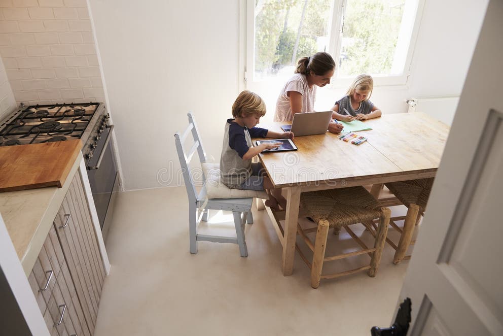 Mum and Two Kids Working at Kitchen Table, Elevated View Stock Image ...