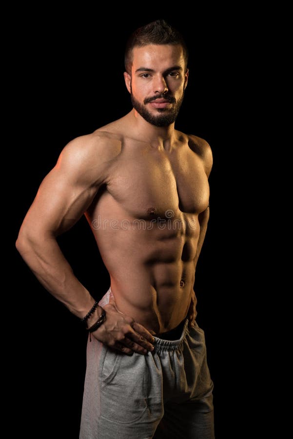 Muscular Athlete Flexing Muscles on Black Background Stock Image ...