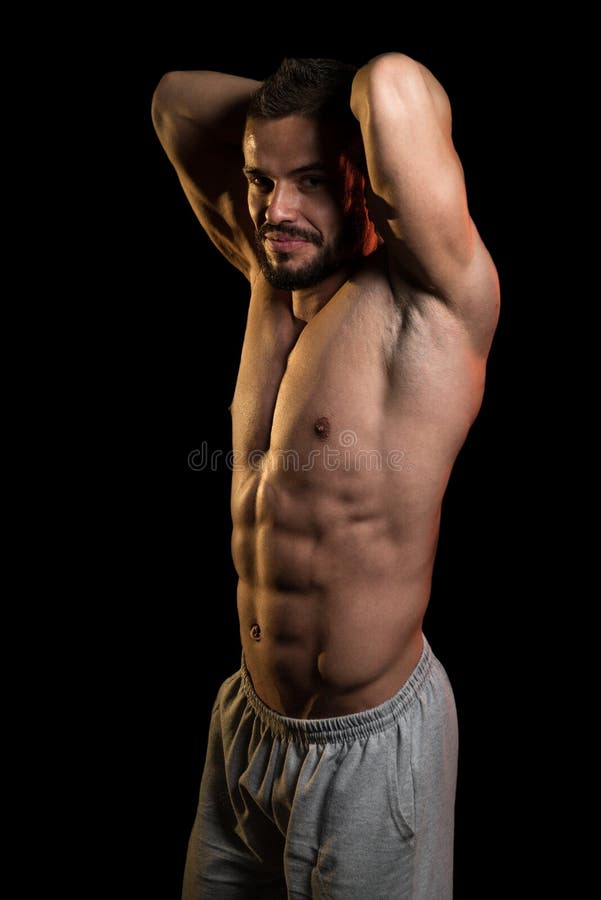 Muscular Athlete Flexing Muscles on Black Background Stock Photo ...
