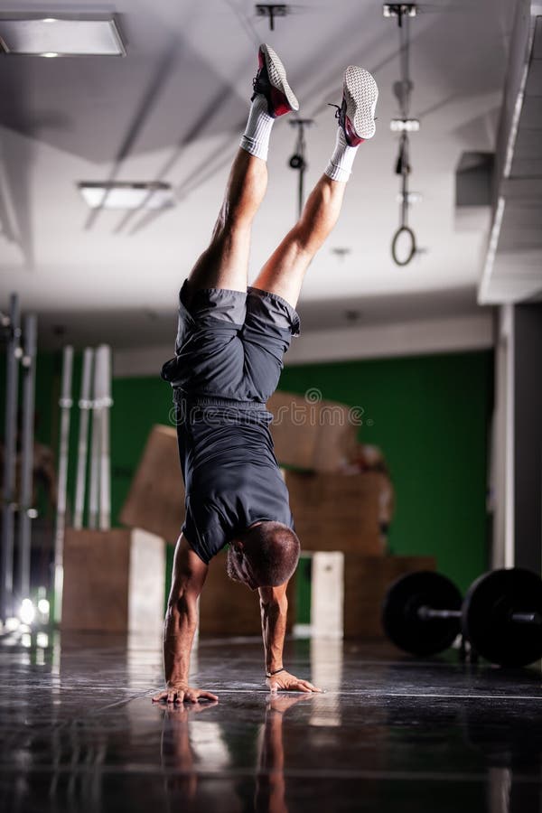 Muscular Athlete Standing and Walking on Hands Upside Down Stock Image ...