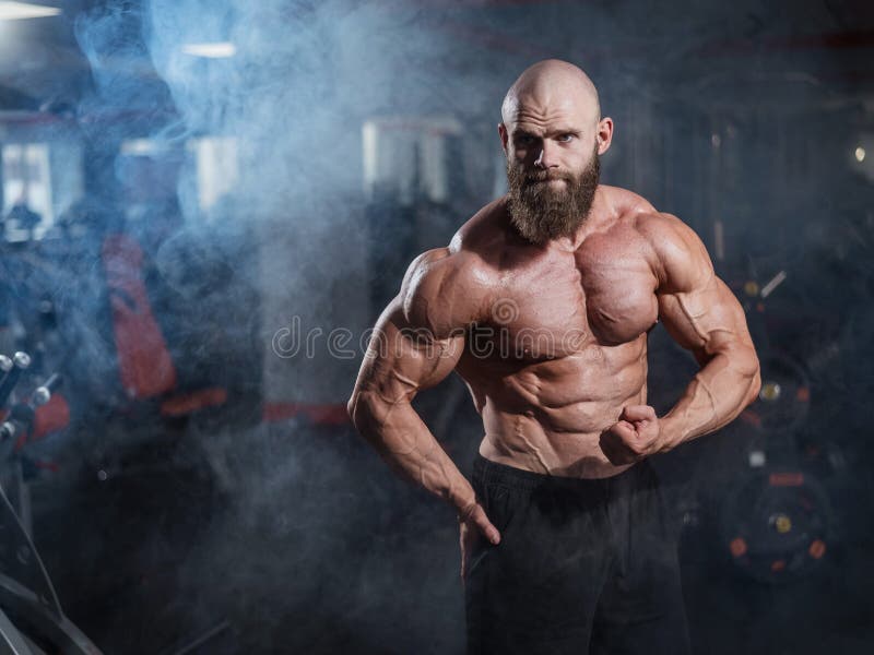 Muscular Bald Man Posing Shirtless. Bodybuilder Showing Off His Shape ...
