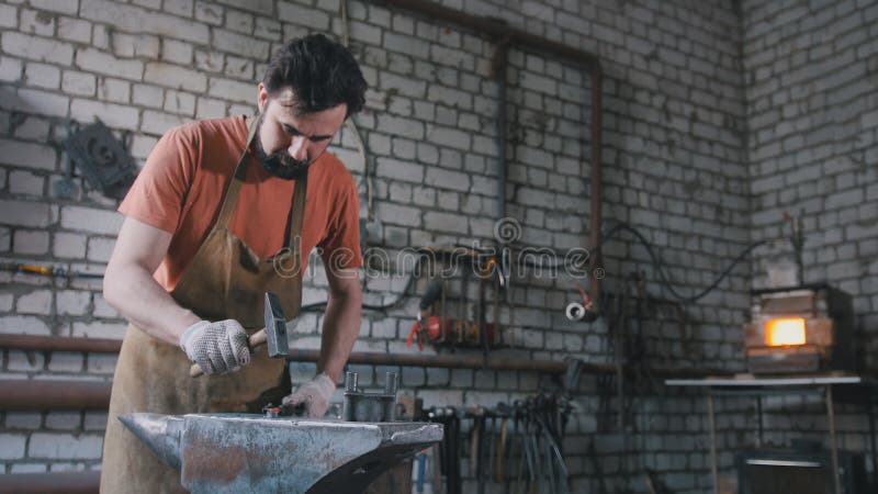 Muscular Man Blacksmith with Hammer in Forge Creating Steel Knife Stock ...