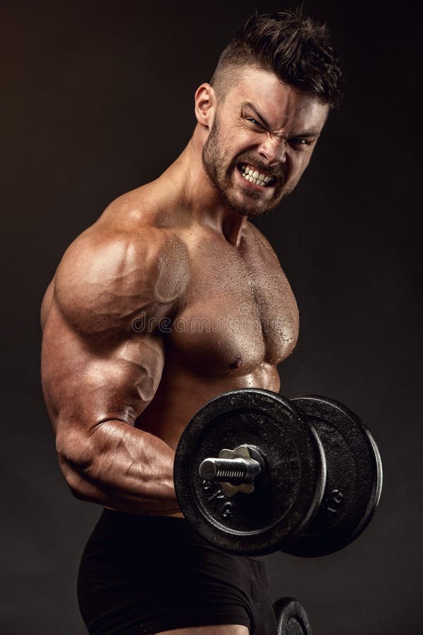 Muscular Bodybuilder Guy Doing Exercises with Dumbbells Stock Photo ...