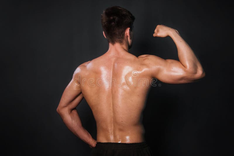 Muscular Bodybuilder Man Posing on Black Background. View from the Back ...