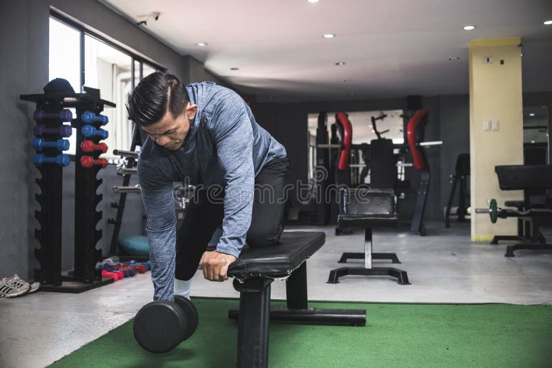 A Muscular and Buff Male Does a Set of Lying Dumbbell Tricep Extensions ...