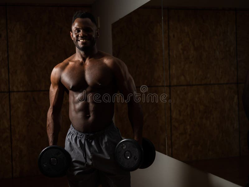 Muscular Dark-skinned Man Doing an Exercise with Dumbbells. Stock Photo ...