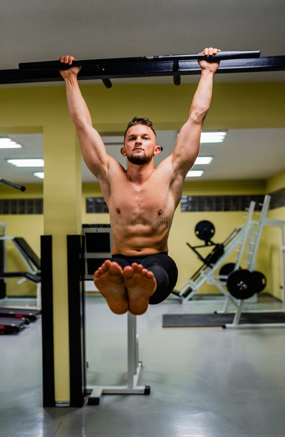Muscular Fit Man Doing Pulling Up on Horizontal Bar at Gym. Stock Photo ...