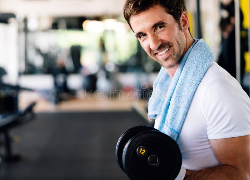 Muscular Man Working Out in Gym Doing Exercises with Dumbbells at ...