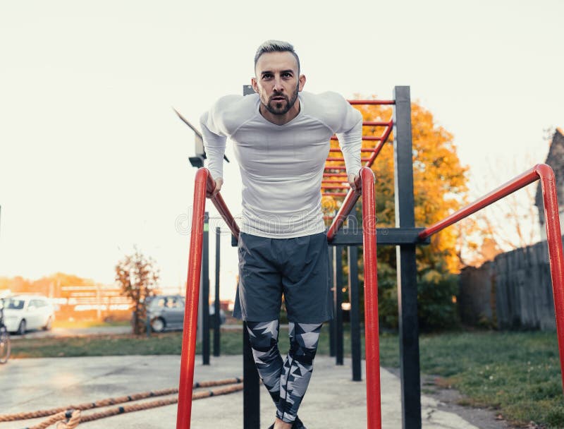 Muscular Good Looking Man Doing Dips on Parallel Bars, Chest Workout ...