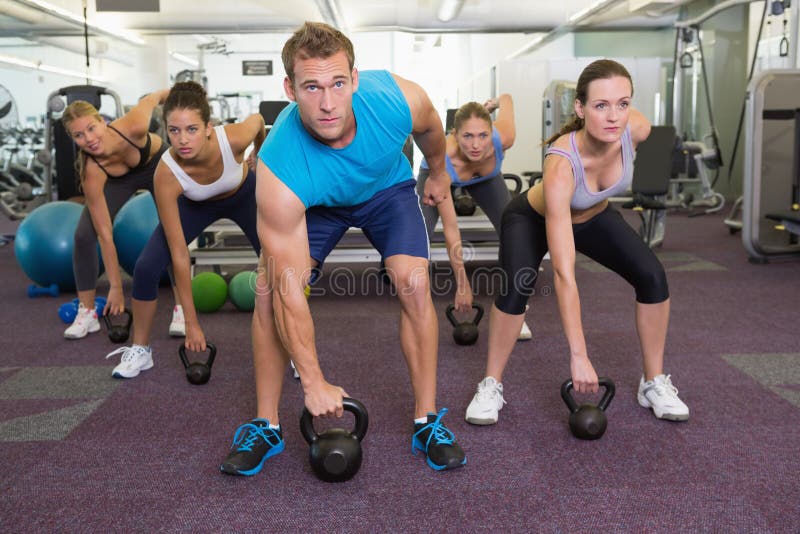 Muscular Instructor Leading Kettlebell Class Stock Image - Image of ...