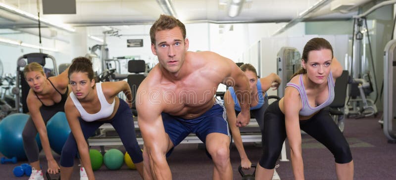 Muscular Instructor Leading Kettlebell Class Stock Image - Image of ...