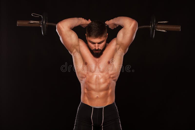 Muscular Male Athlete is Training by Lifting the Barbell Stock Photo ...