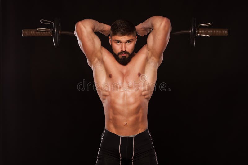 Muscular Male Athlete is Training by Lifting the Barbell Stock Photo ...