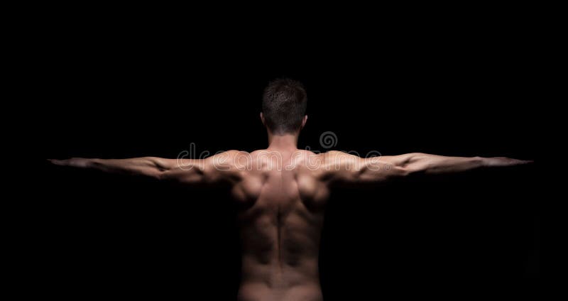 Muscular Man with Arms Stretched Out on Black Background Stock Photo ...
